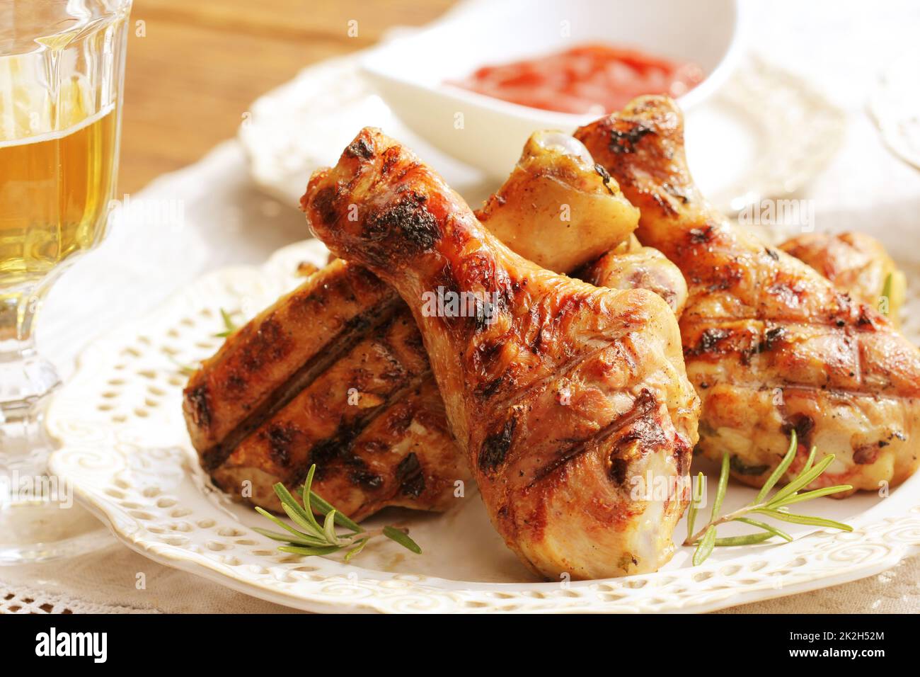Grilled chicken legs with rosemary on table Stock Photo - Alamy