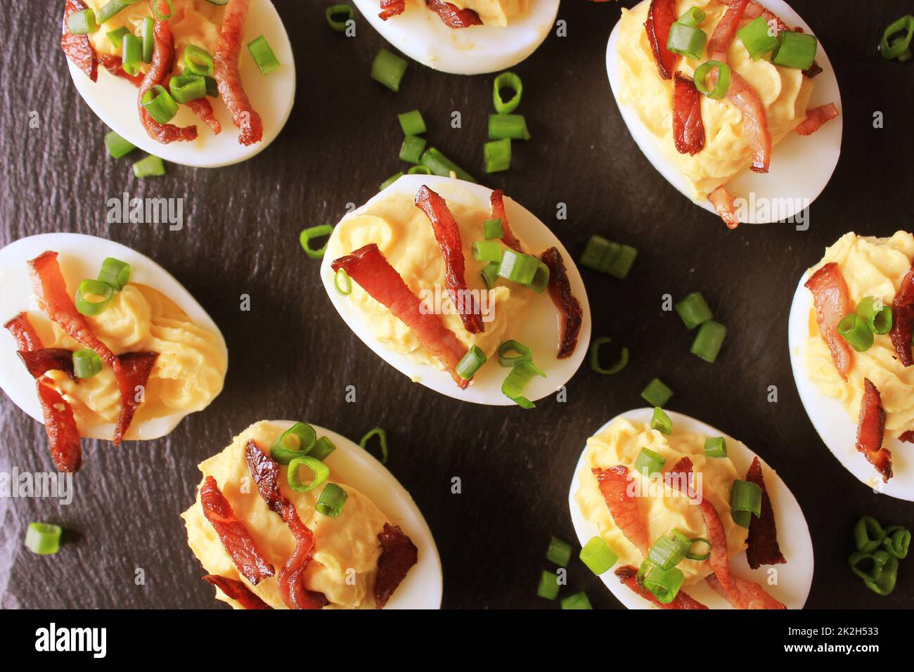 Stuffed Deviled Eggs witg bacon on black background Stock Photo - Alamy