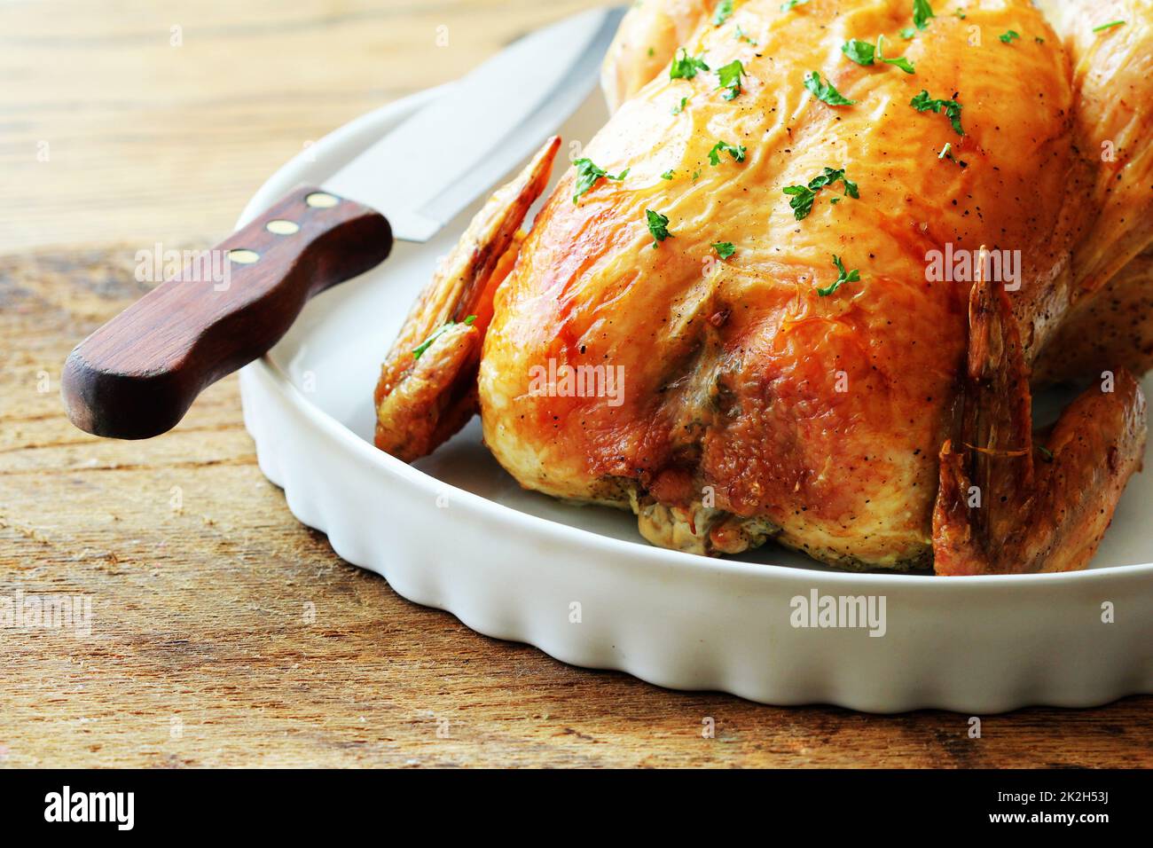 Whole roasted chicken on white plate Stock Photo - Alamy