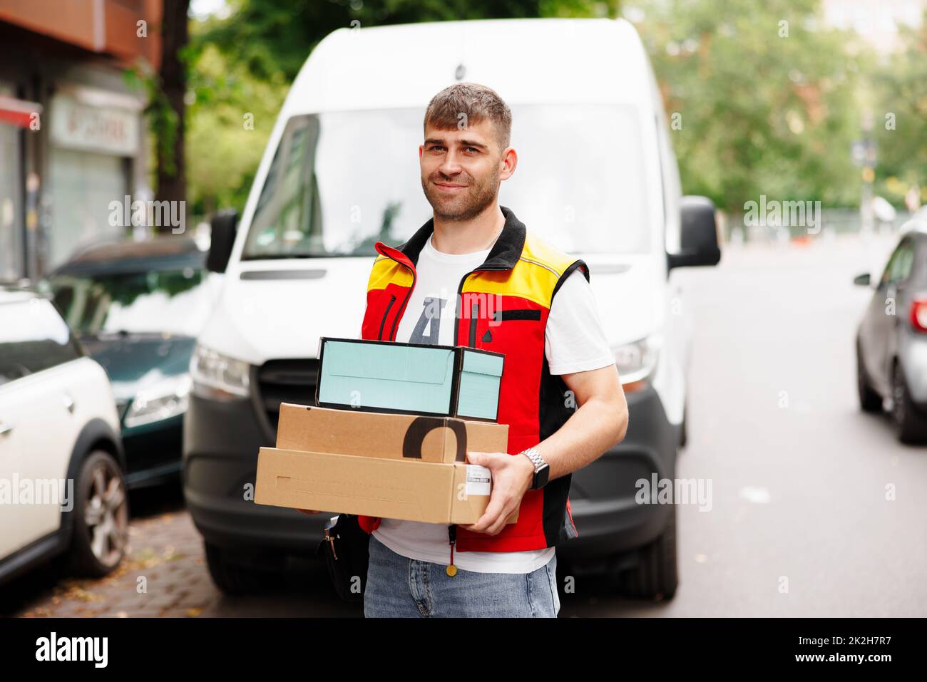 Image of delivery man holding parcel box Stock Photo - Alamy