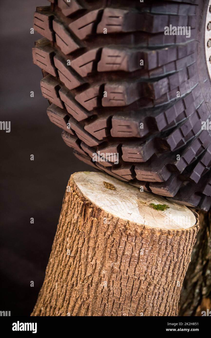 Off road tire on a piece of wood Stock Photo - Alamy