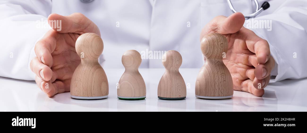 Doctor Protecting Family Stock Photo - Alamy