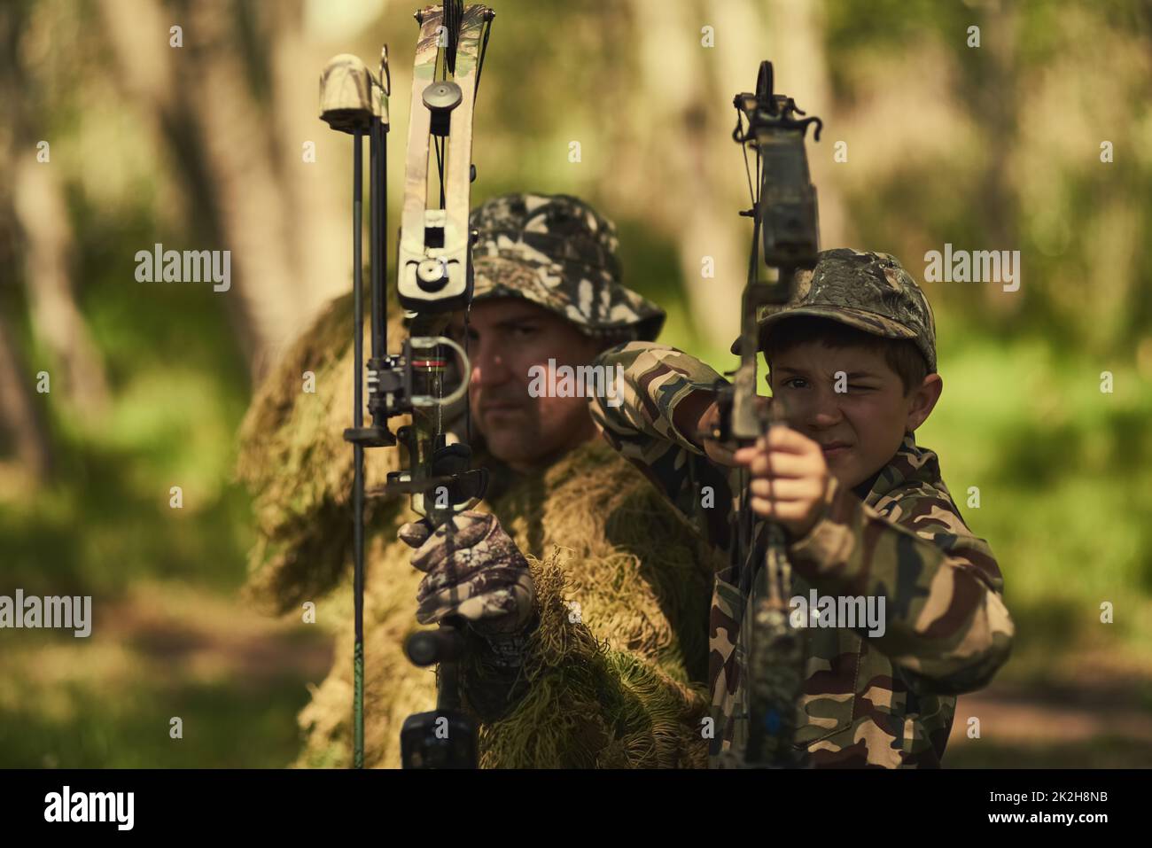 Theyre a deadly duo. Portrait of a father and son in camouflage hunting ...