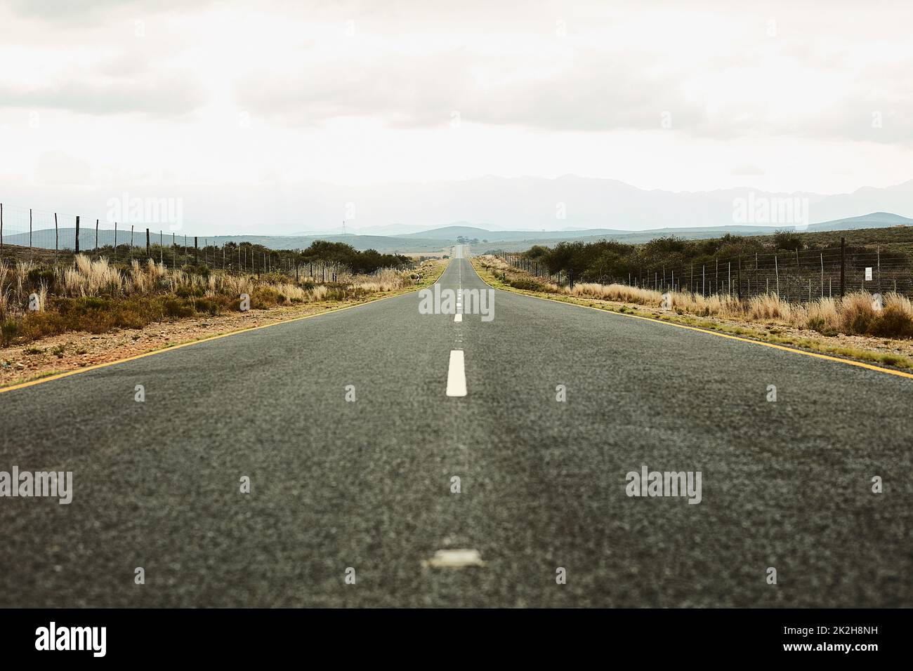 The open road. Shot of a long open road stretching out far away into the distance Stock Photo ...