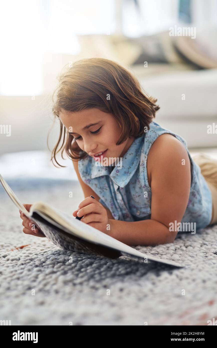 Practising her handwriting. Cropped shot of a young girl writing in a ...