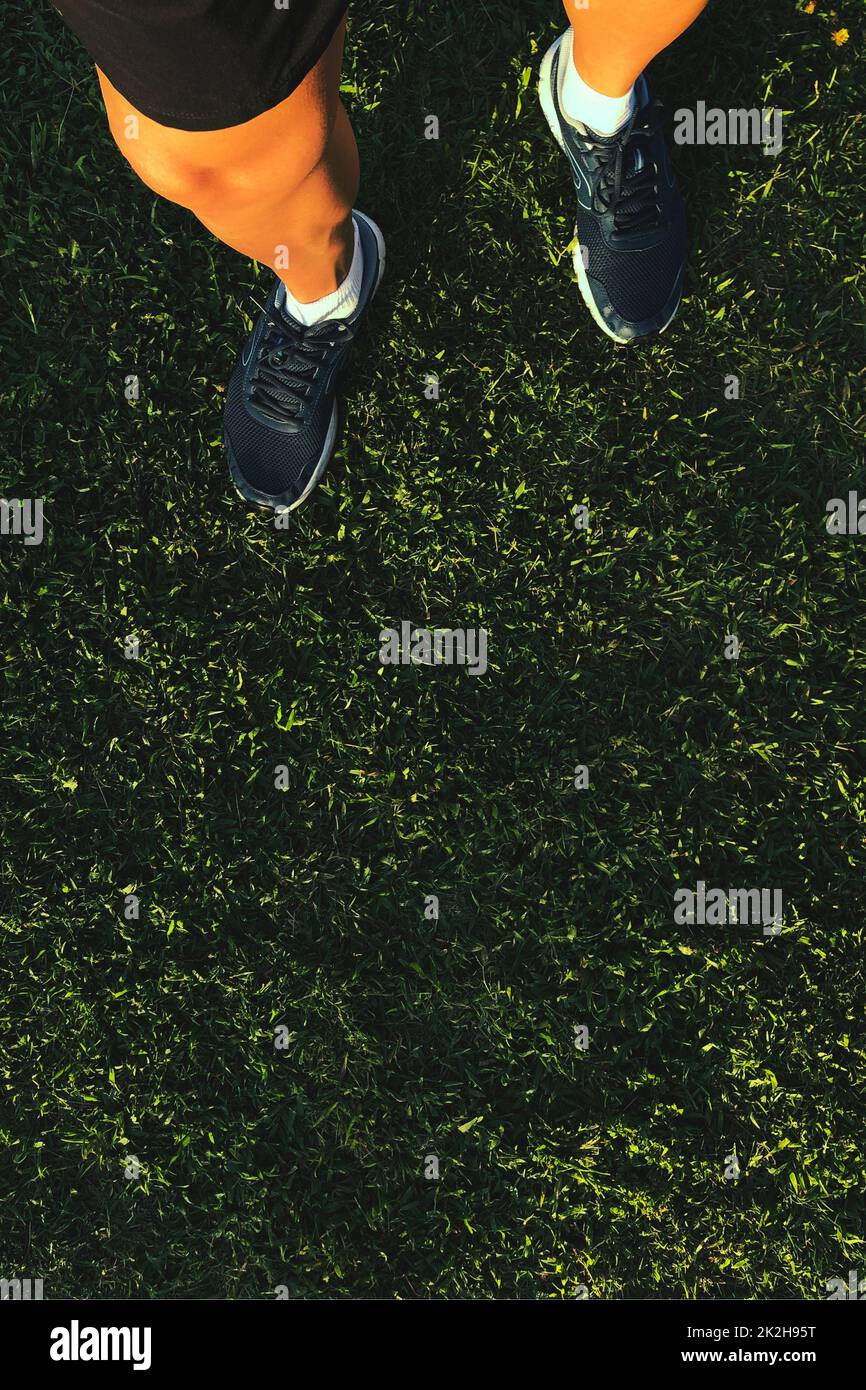 Top view of a male feet with running shoes and on grass ground Stock ...