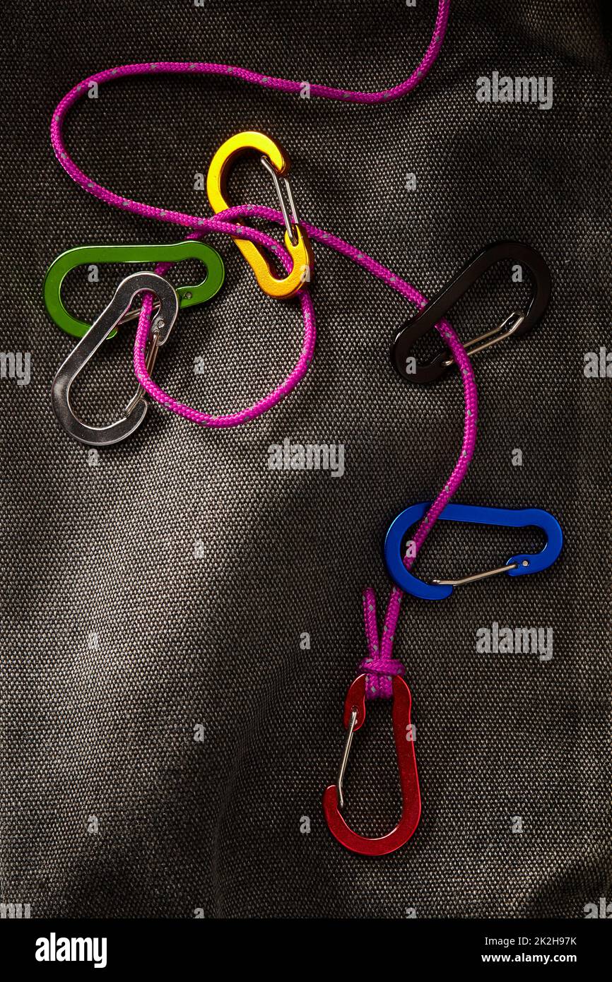 colourful carabiner accessories on a small purple rope with dramatic ...