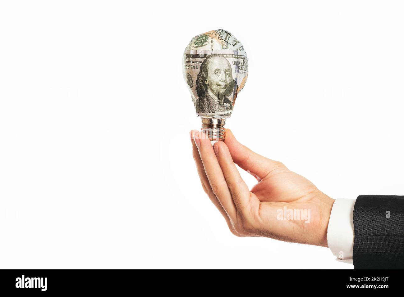 Businessman's Hand holding a a light bulb which wrapped 100 dollar ...