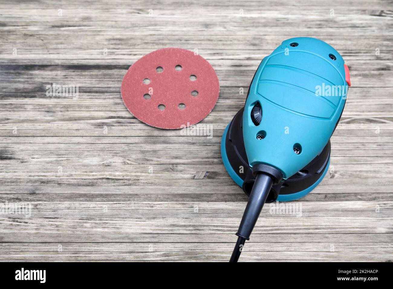 Random orbital sander on wooden background with sanding disc Stock ...