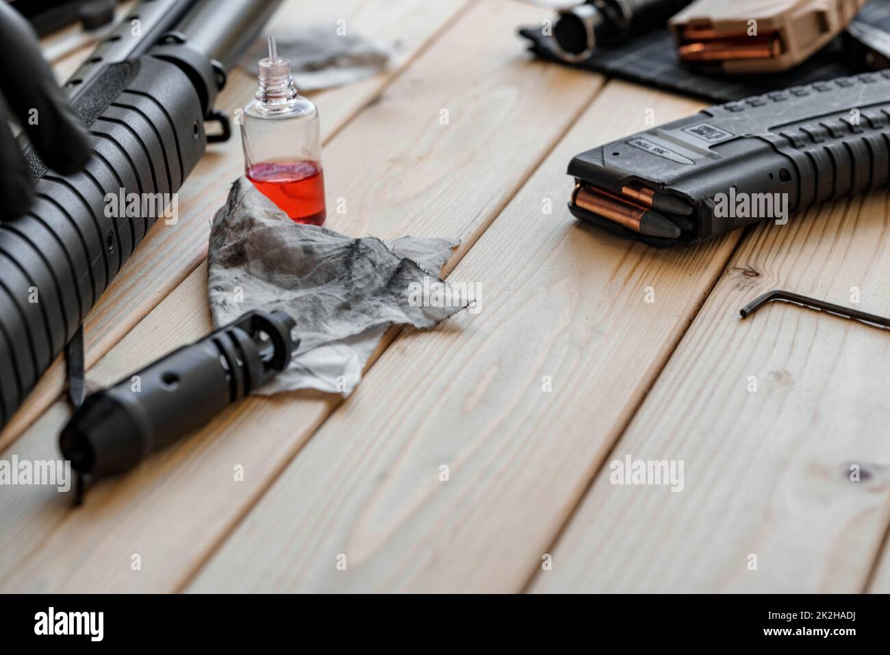 Disassembled rifle with cleaning tools on table of weapons workshop ...