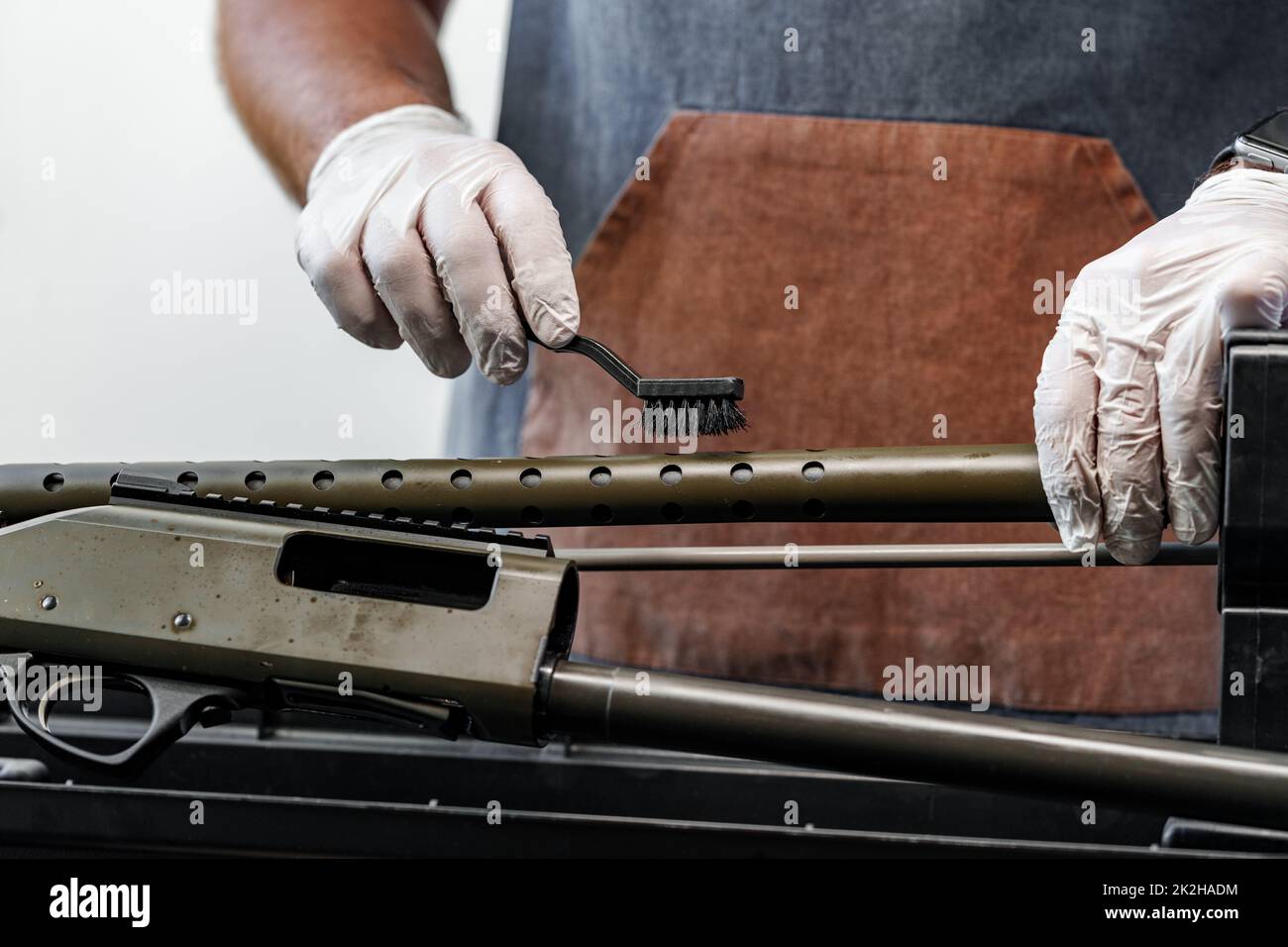 The gunsmith maintaining his rifle in a workshop Stock Photo - Alamy