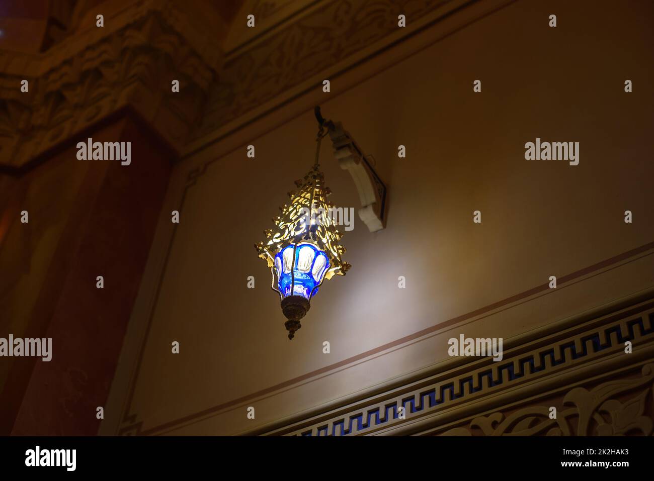 Vintage lamp hanging on beige wall of medieval castle Stock Photo - Alamy