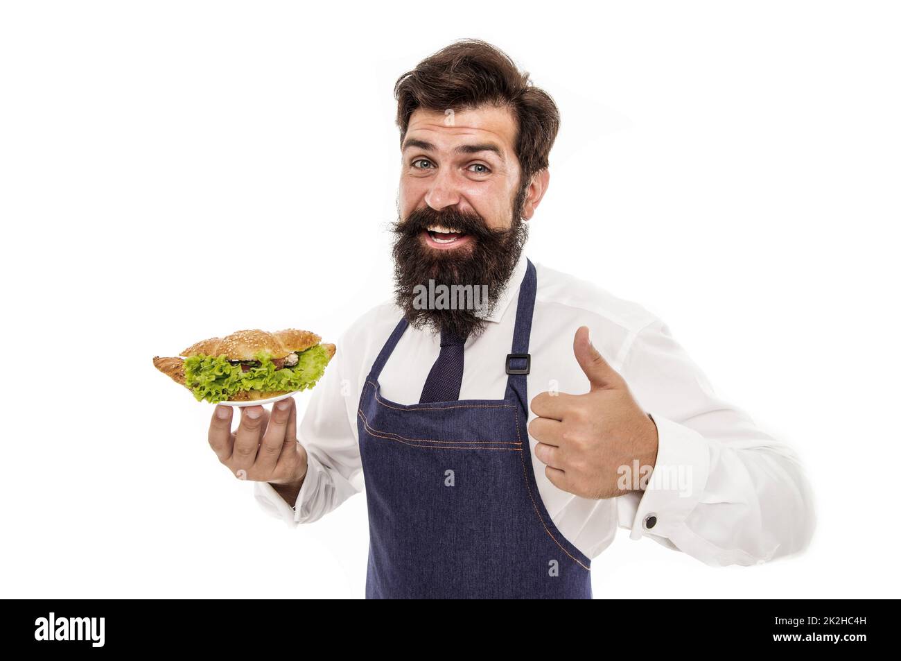 Chef proud of croissant meal. Man bearded waiter wear apron carry plate ...