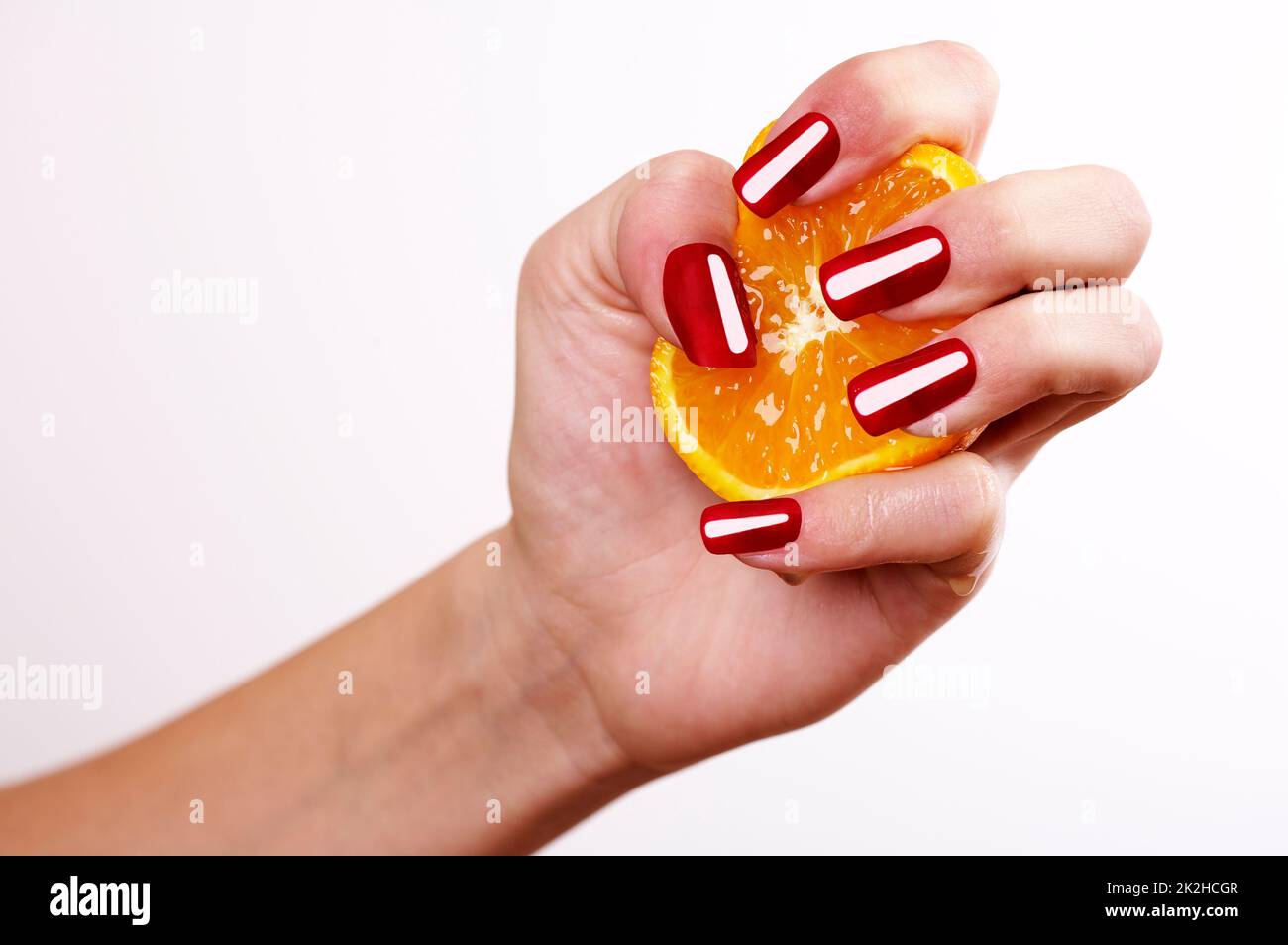 Hand squeezes out orange Stock Photo - Alamy