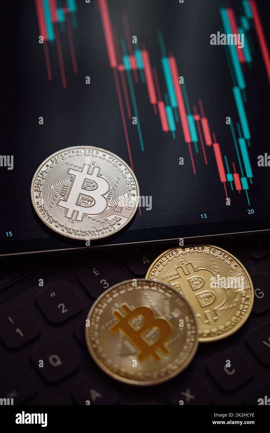 Bitcoin cryptocurrency with candle stick graph chart, laptop keyboard ...