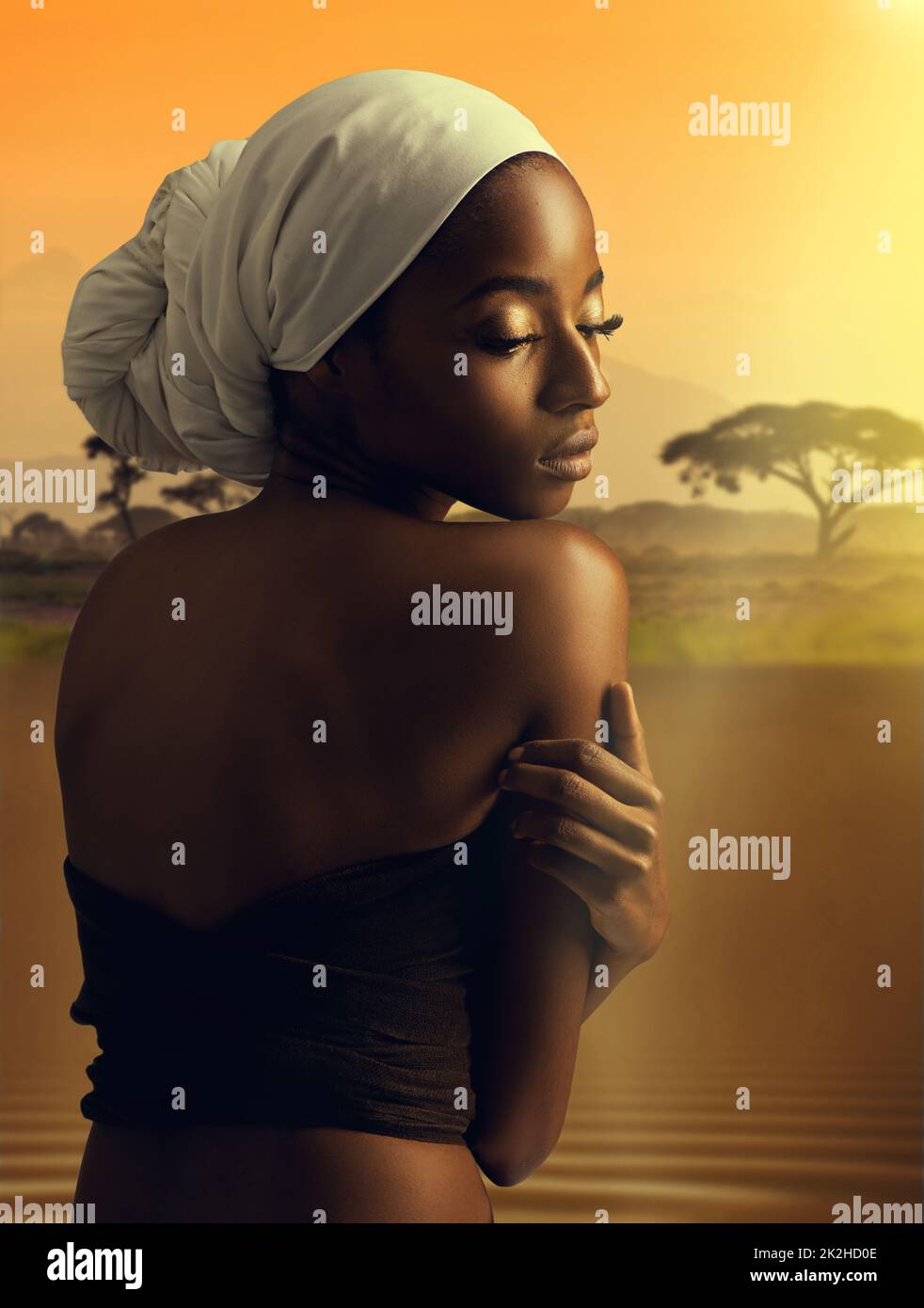 African allure. a beautiful woman standing against the backdrop of an ...