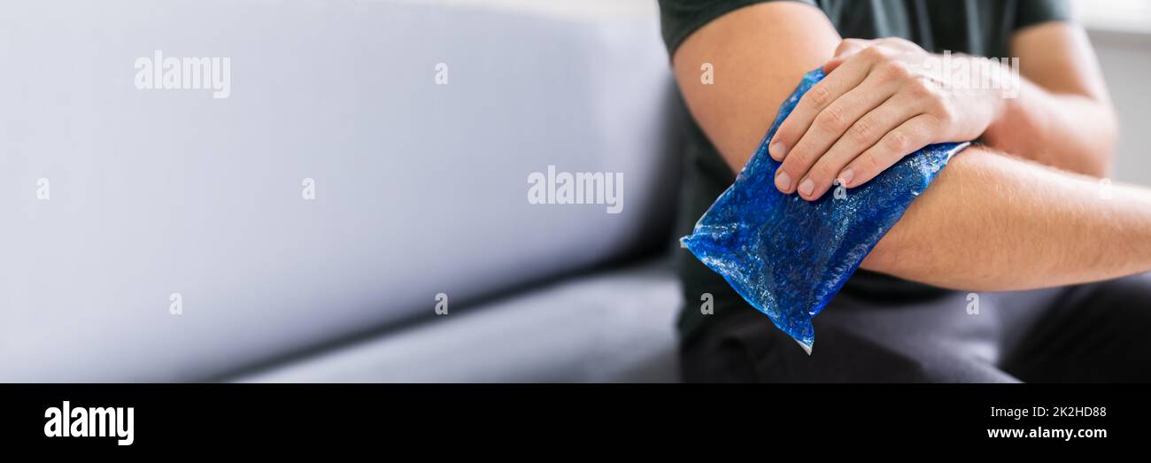 Man Using Ice Gel Pack On Arm Stock Photo - Alamy
