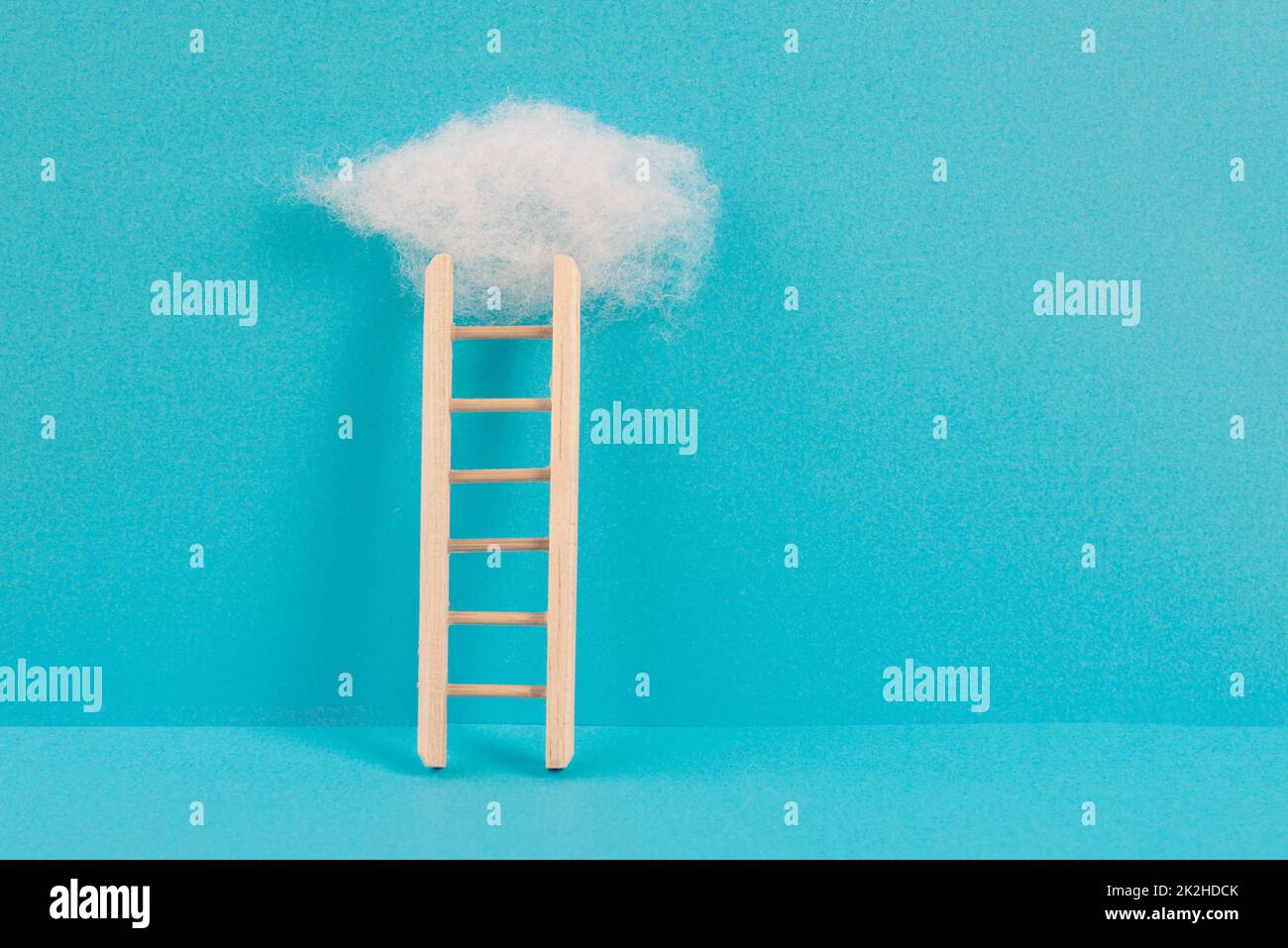 Ladder with a cloud on top, blue colored background, copy space ...