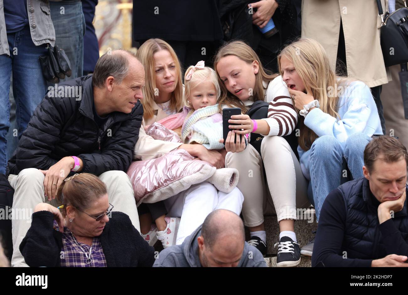 People watch the television coverage on their mobile phones. The State ...