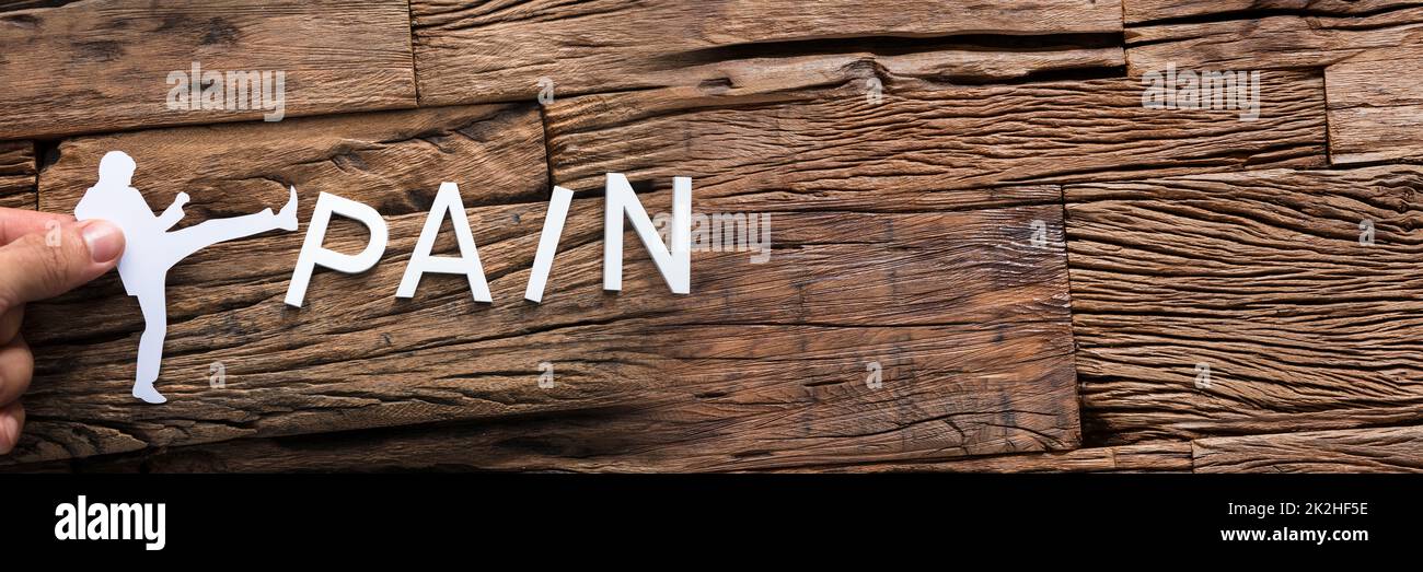 Pain Fight And Relief Solution. Kicking Word Stock Photo - Alamy