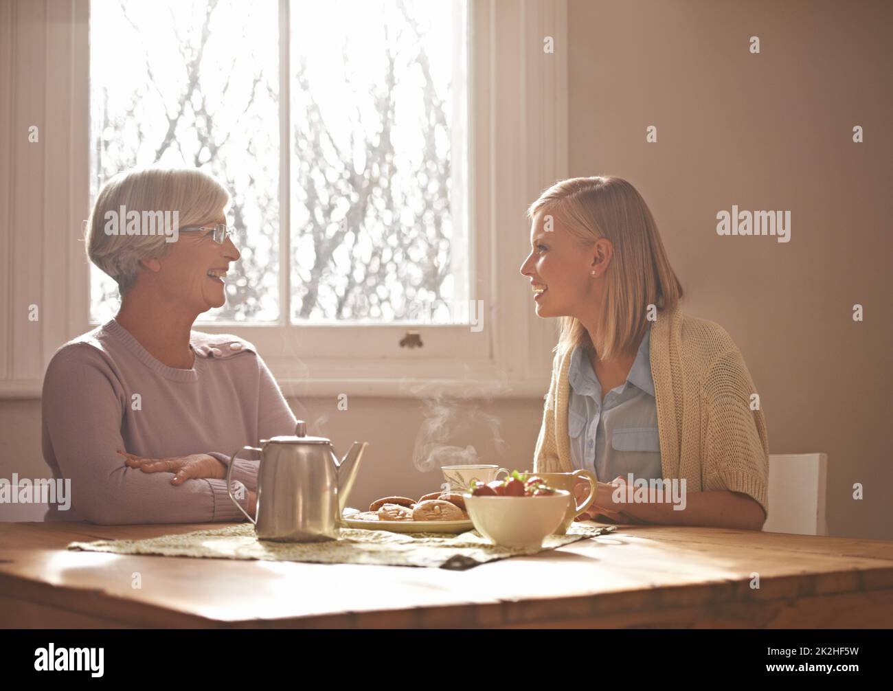 Tea with gran..its the best. an attractive young woman visiting her ...
