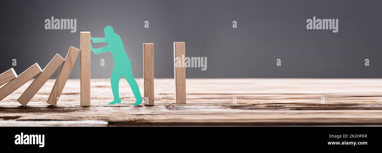 Business Crisis Falling Domino Intervention. Stop Risk Stock Photo - Alamy