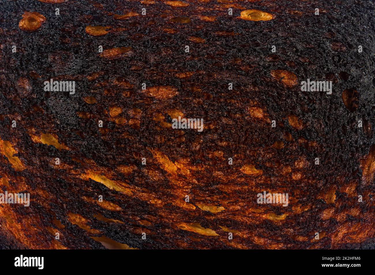 black burned bread slice texture background Stock Photo - Alamy