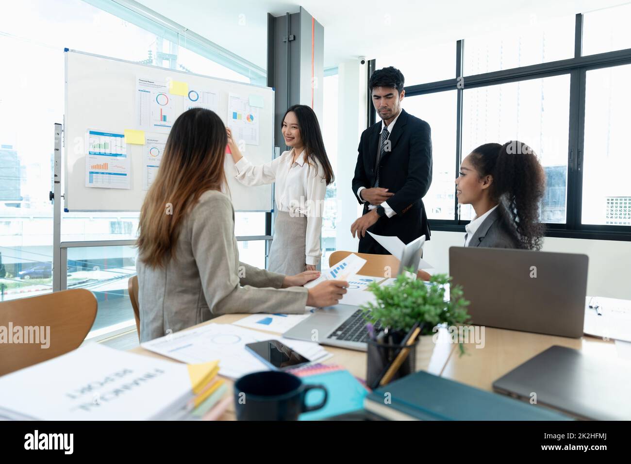 Diverse business people meeting new startup project pointing graph ...