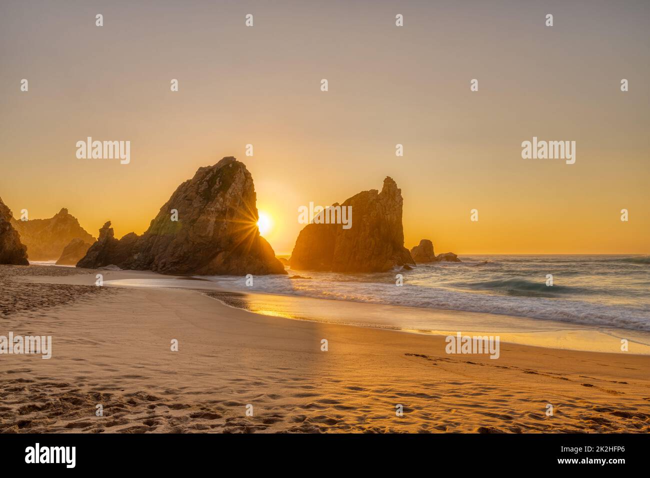 Beautiful sunset on a beach with sea stacks at the portuguese atlantic ...