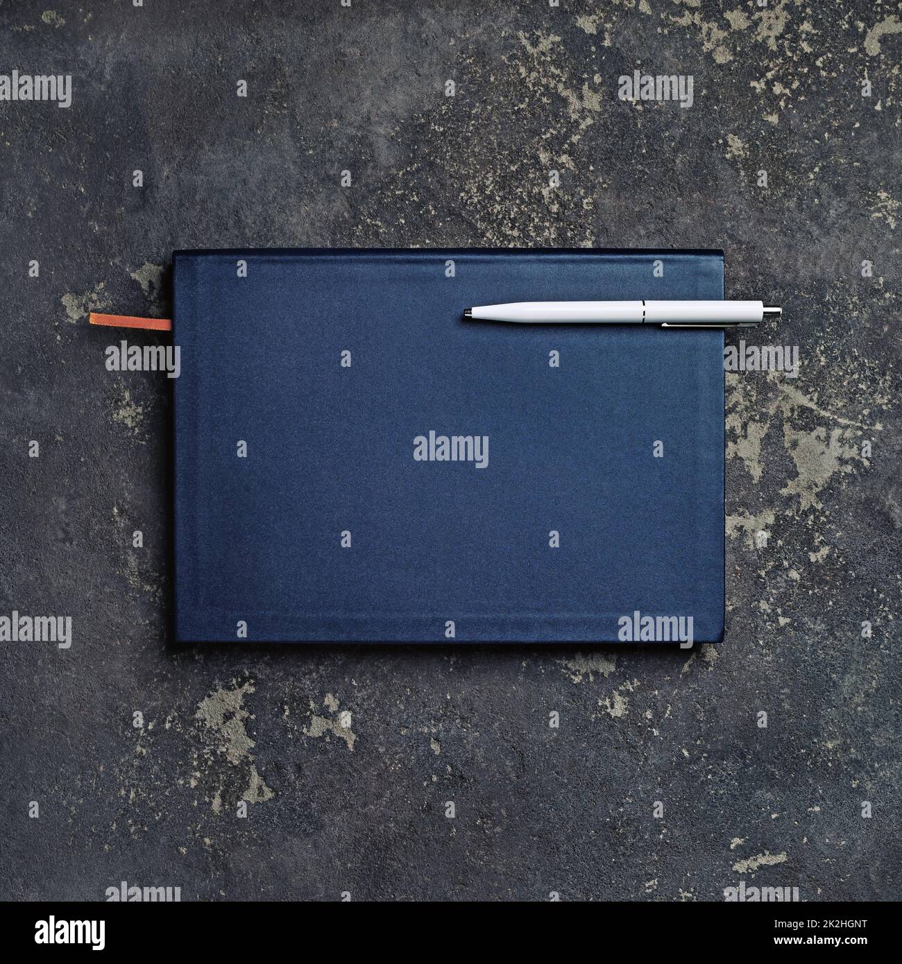 Closed notepad and pen Stock Photo - Alamy