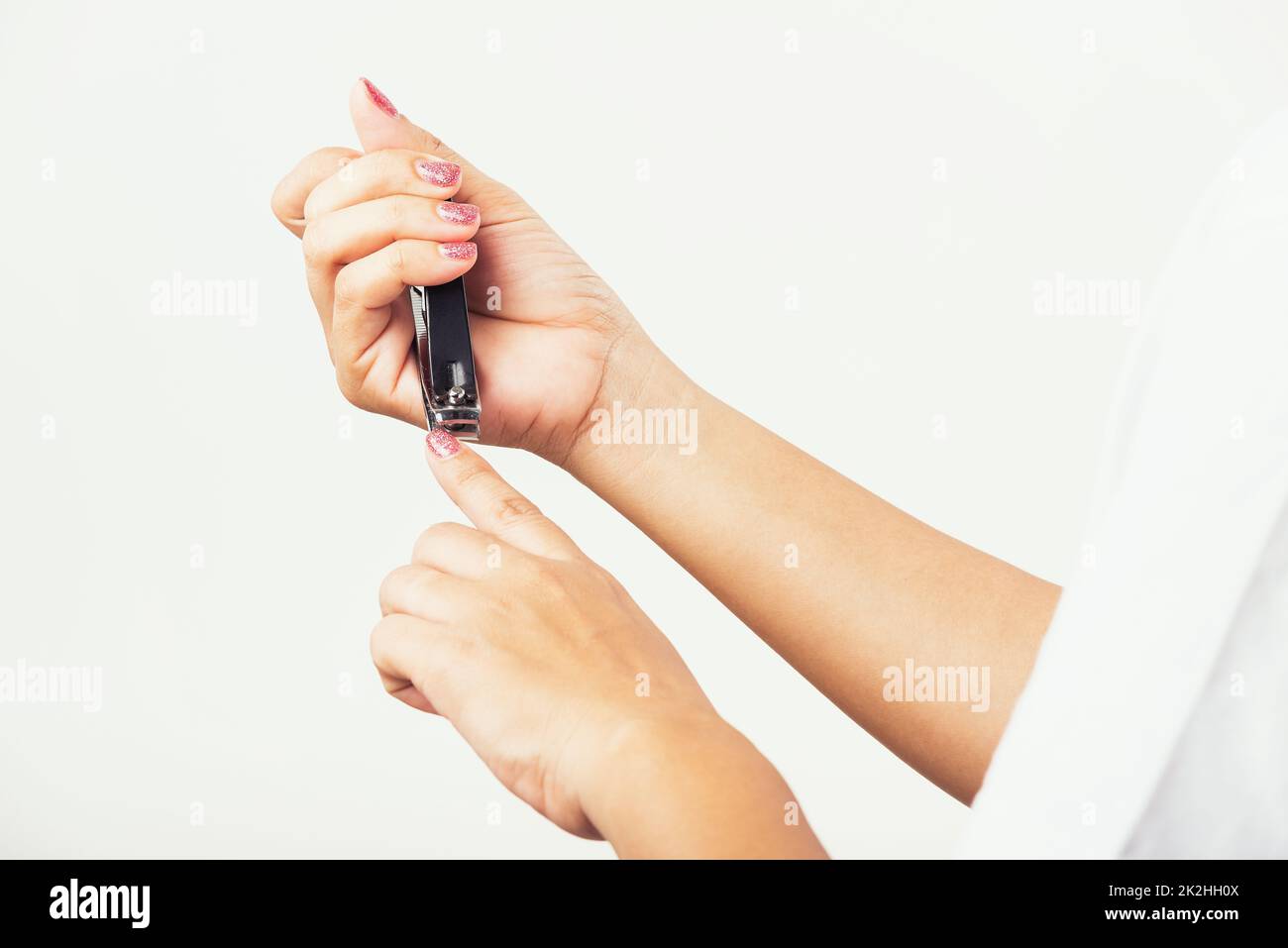Woman cutting nails on finger using a nail clipper Stock Photo - Alamy