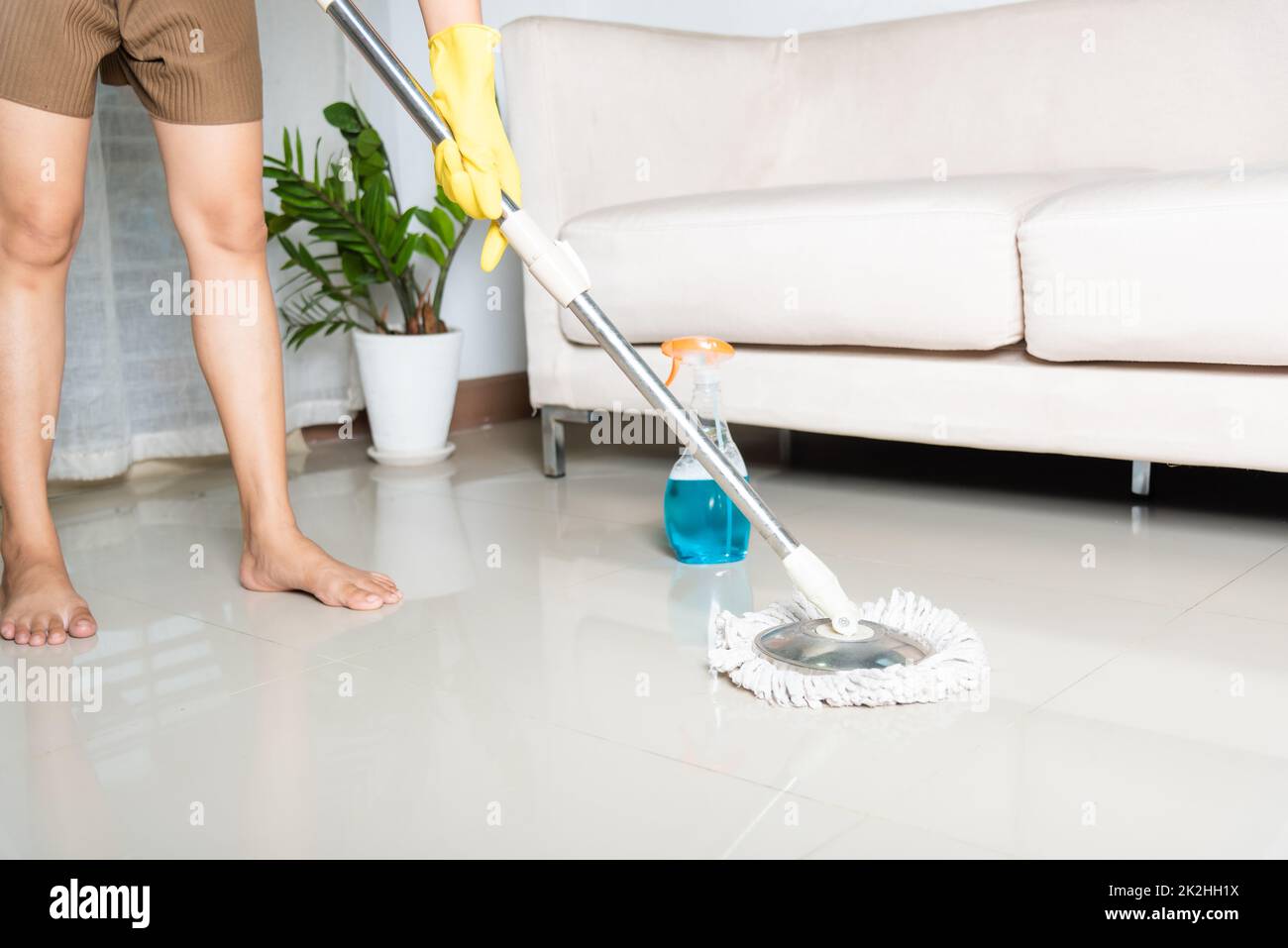 Asian woman washes the floor with a mop and rag indoors Stock Photo - Alamy