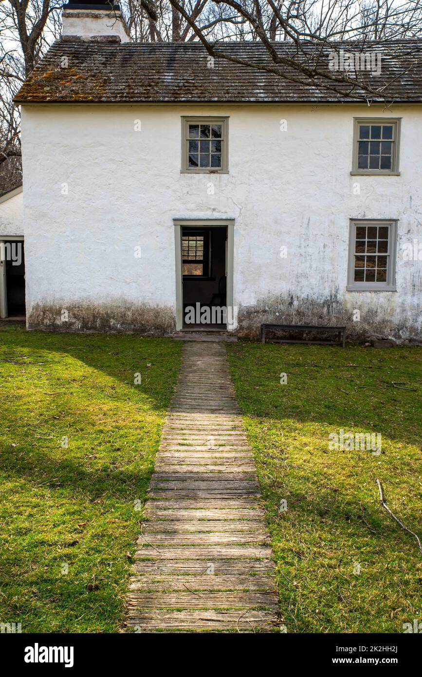 Idyllic path leads to open door of whitewashed stone cottage Stock ...
