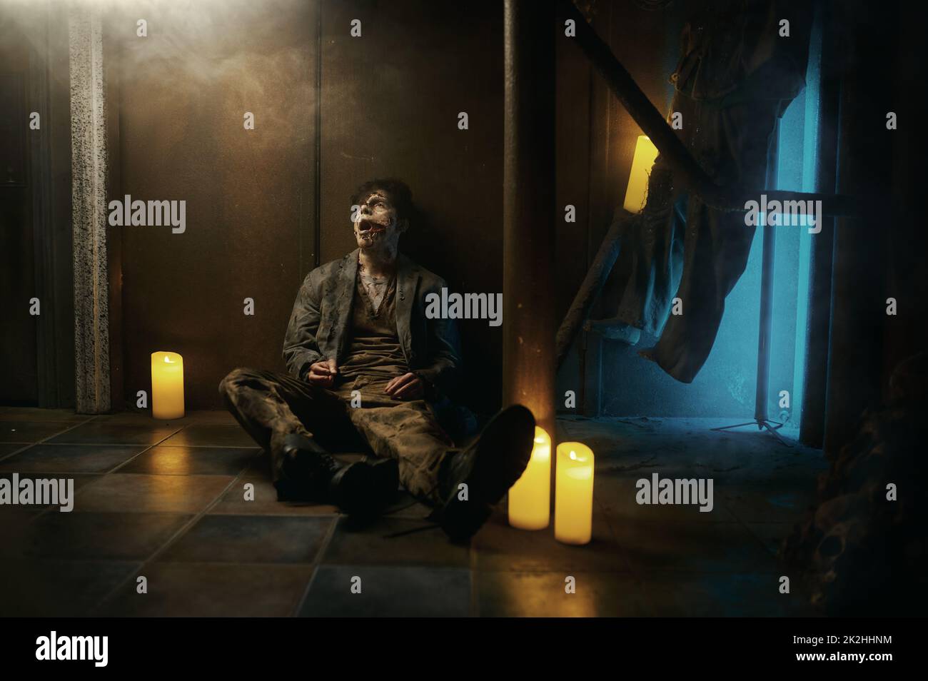 Tired and exhausted zombie sitting on floor Stock Photo - Alamy