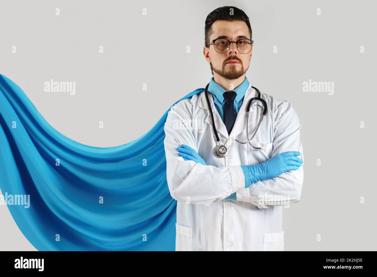 Brave man superhero doctor with blue cape Stock Photo - Alamy