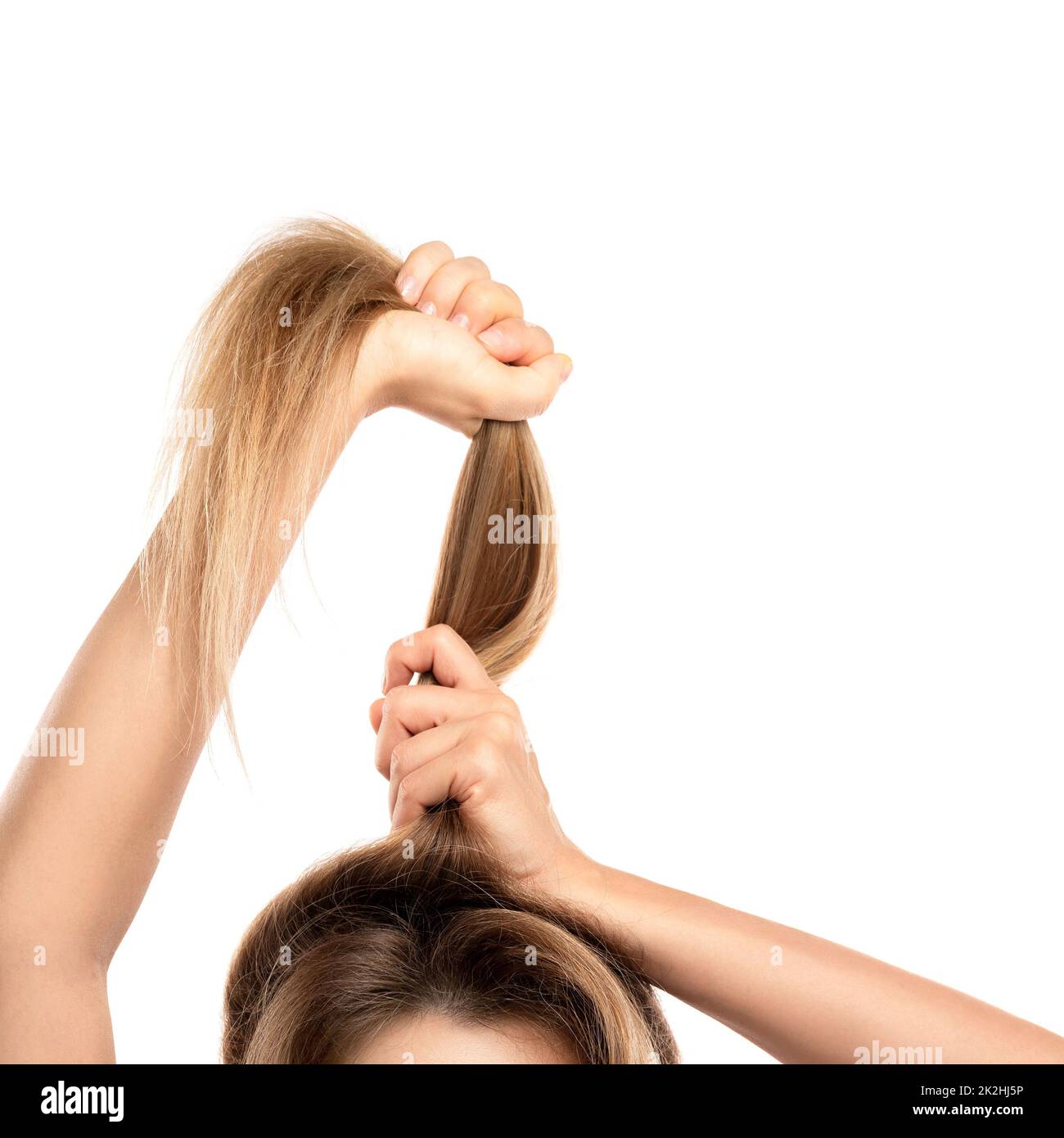Woman is holding her healthy and long hair Stock Photo - Alamy