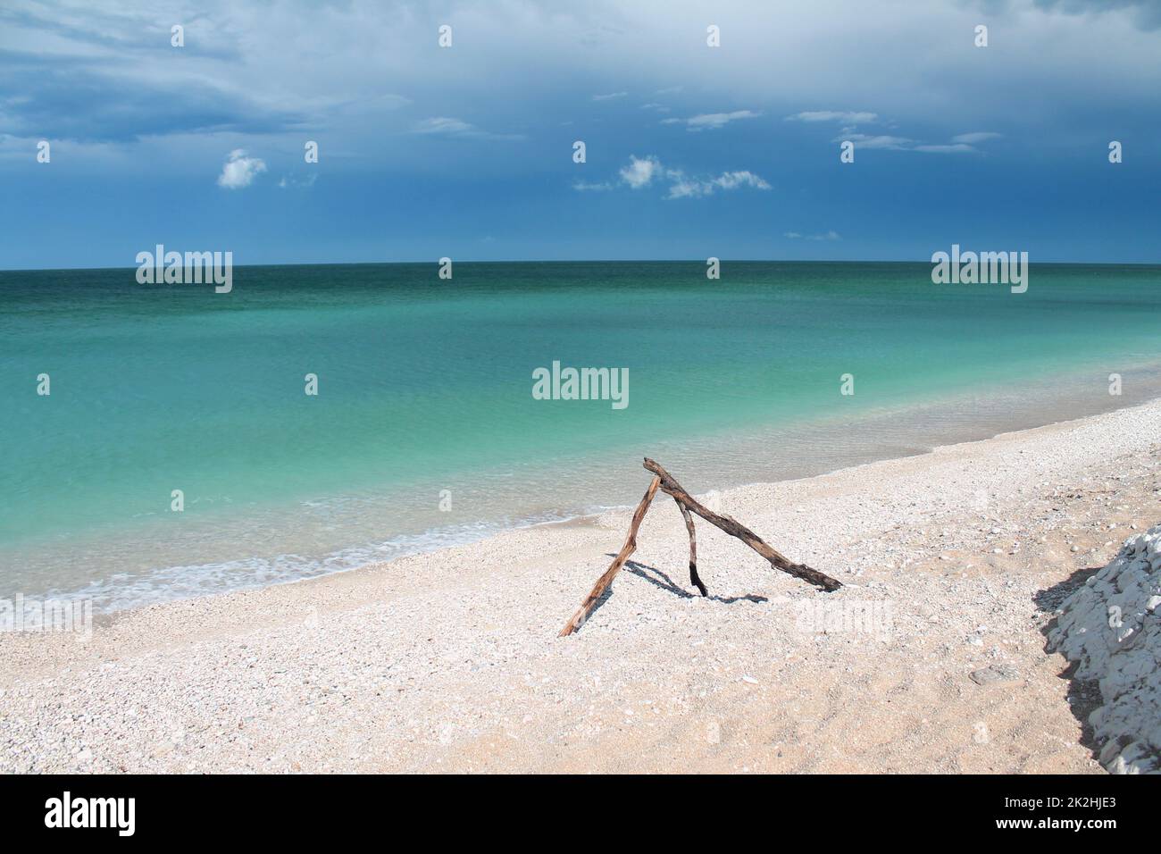 The pyramid pieces of wood on the white sand beach with turquoise ...