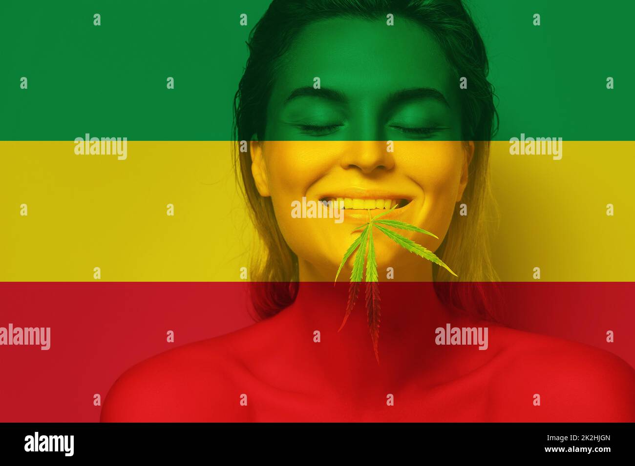 Beautiful woman with a cannabis leaf in colors of Rastafarian flag ...