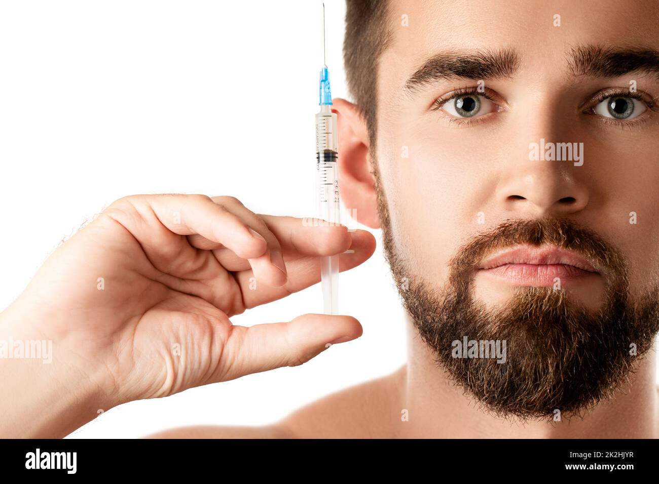 Handsome man holding syringe with a filler on white background Stock ...
