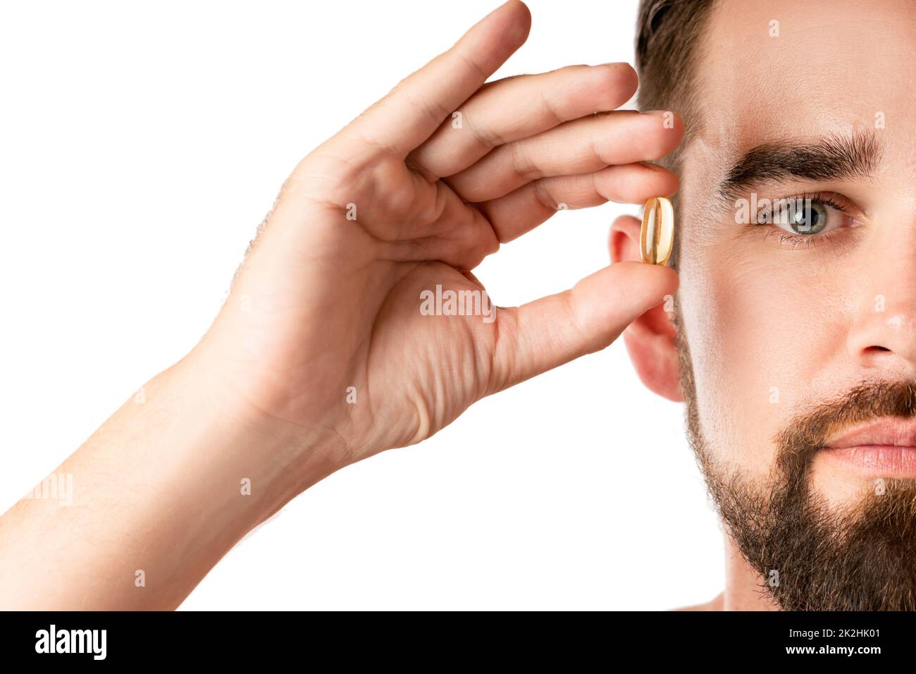 Man holding capsule with a fish or krill oil source of fatty acids such ...
