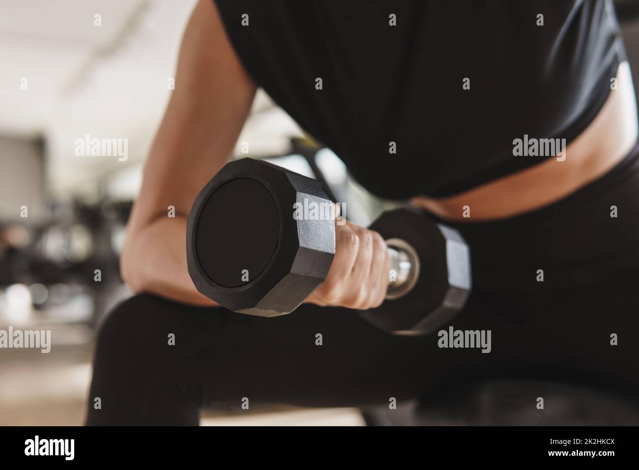 Female hand with a dumbbell during biceps curl exercise Stock Photo - Alamy