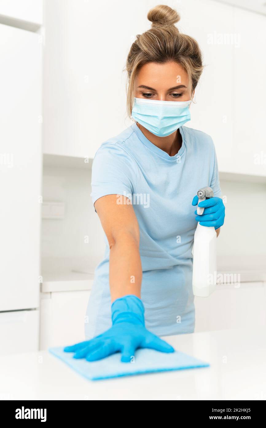 Woman worker wearing prevention mask and gloves during apartment ...