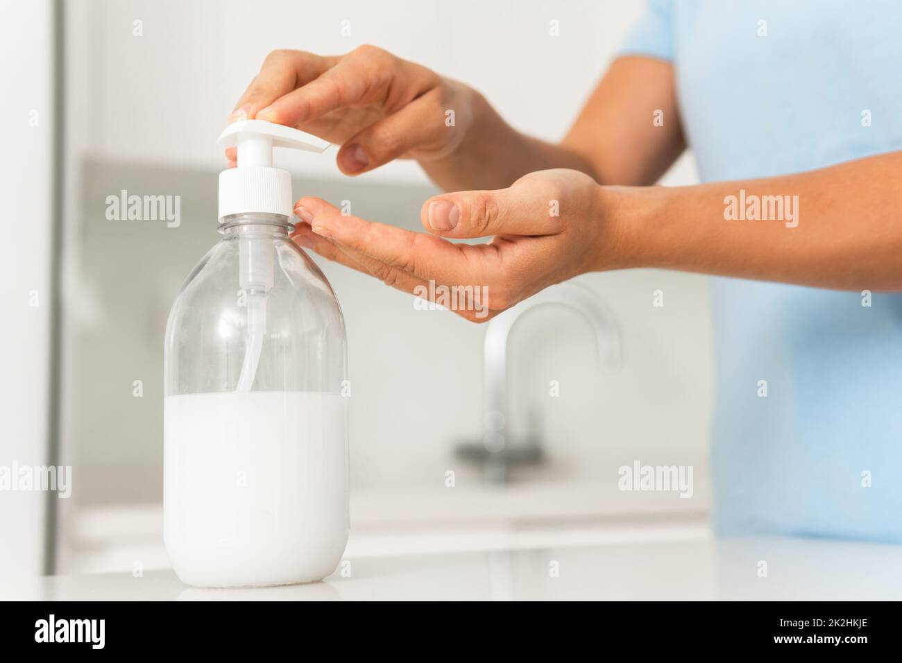 Woman using hand sanitizer or liquid soap for hands disinfection Stock ...