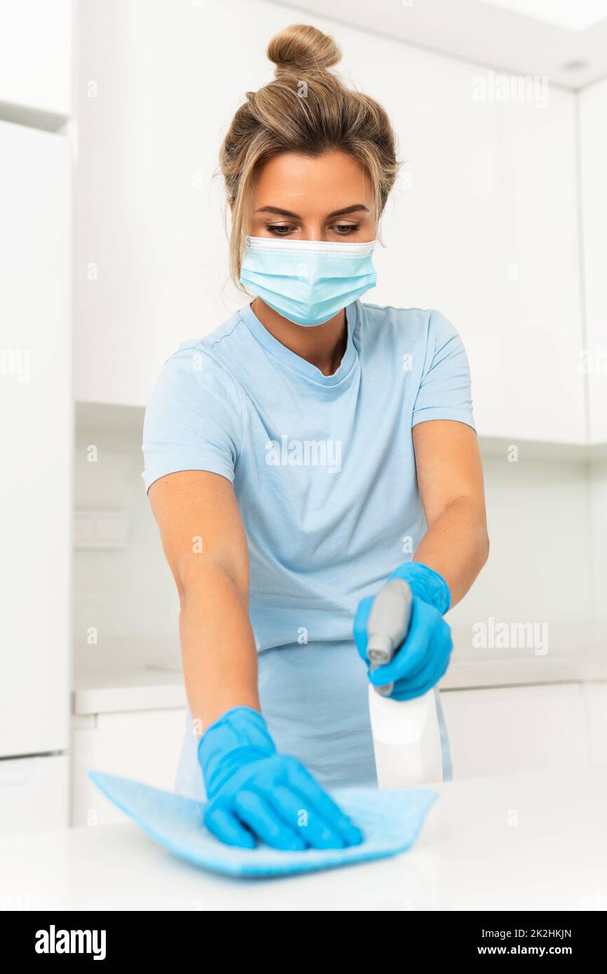 Woman worker wearing prevention mask and gloves during apartment ...