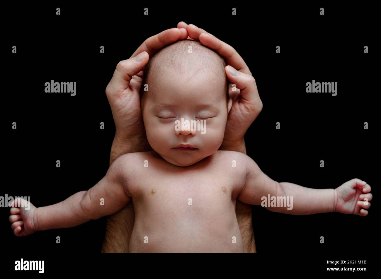 Cute newborn baby lying in the father's hands Stock Photo - Alamy