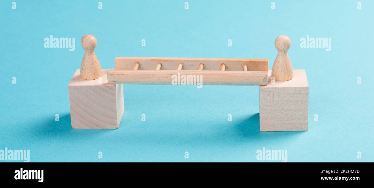 Two people connect by a ladder, buliding a bridge between men ...