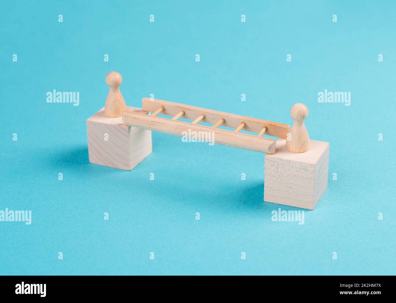 Two people connect by a ladder, buliding a bridge between men ...