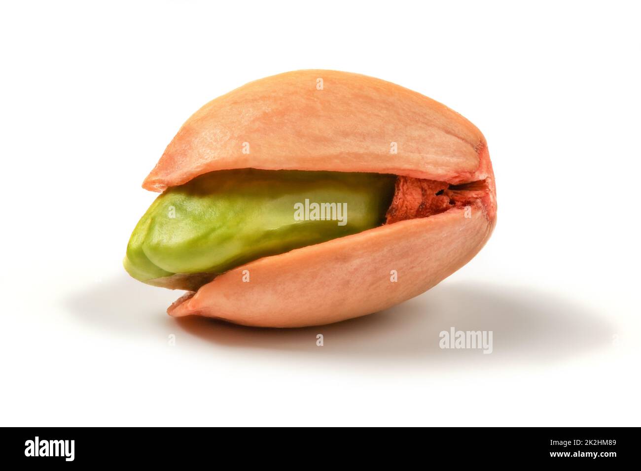 Single pistachio shell, with peeled green shell inside, isolated on ...