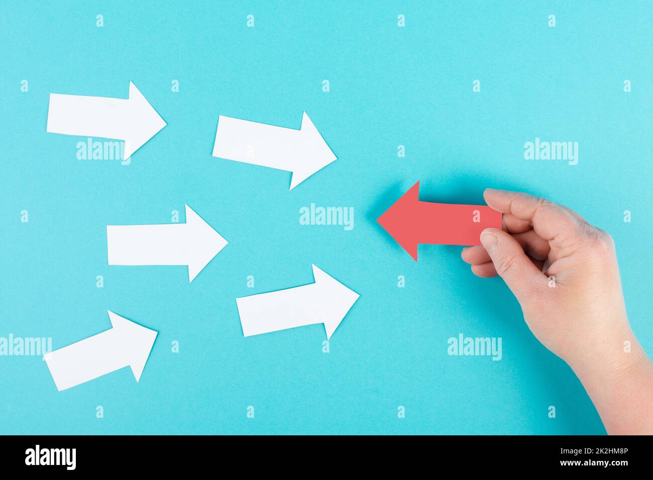 White arrows on a blue background, one red is standing out, do ...