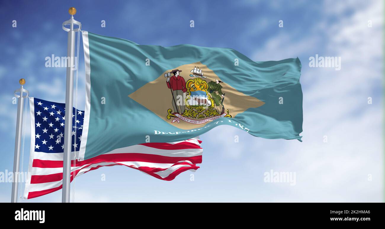The Delaware state flag waving along with the national flag of the ...